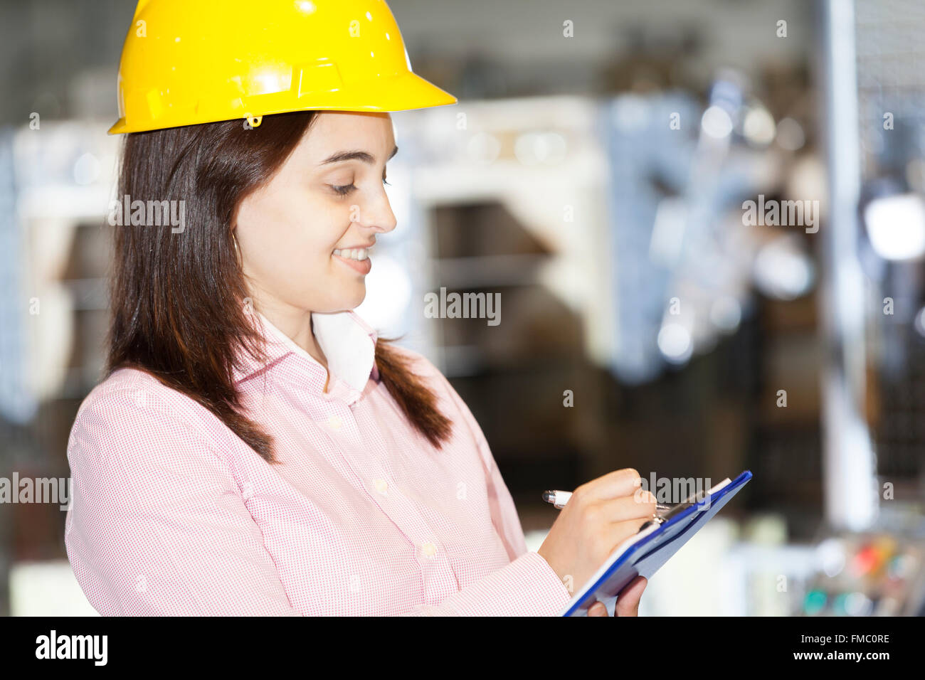 Mechanical engineer taking notes at metallurgy factory Stock Photo - Alamy