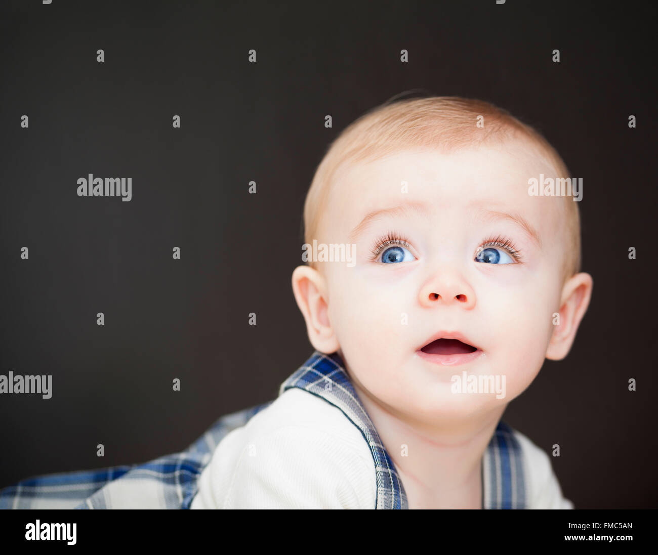 Portrait of adorable baby boy looking up Stock Photo - Alamy