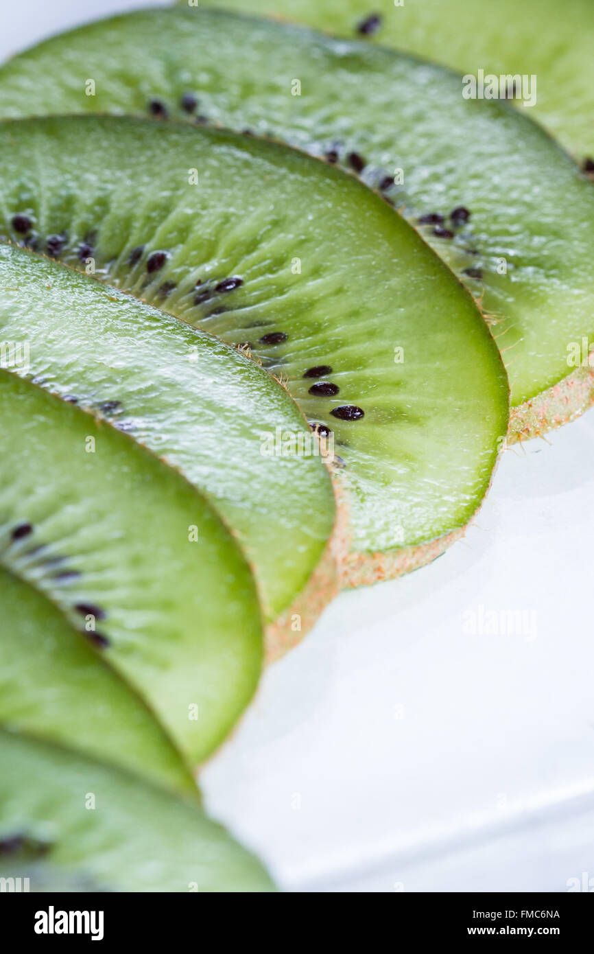 close up of a fresh kiwi sliced in half revealing a beautiful pattern ...