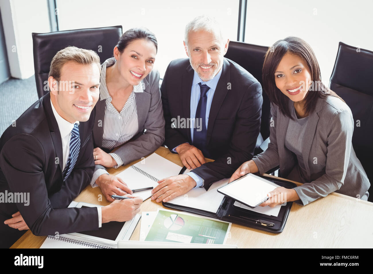 Businesspeople smiling in conference room Stock Photo - Alamy