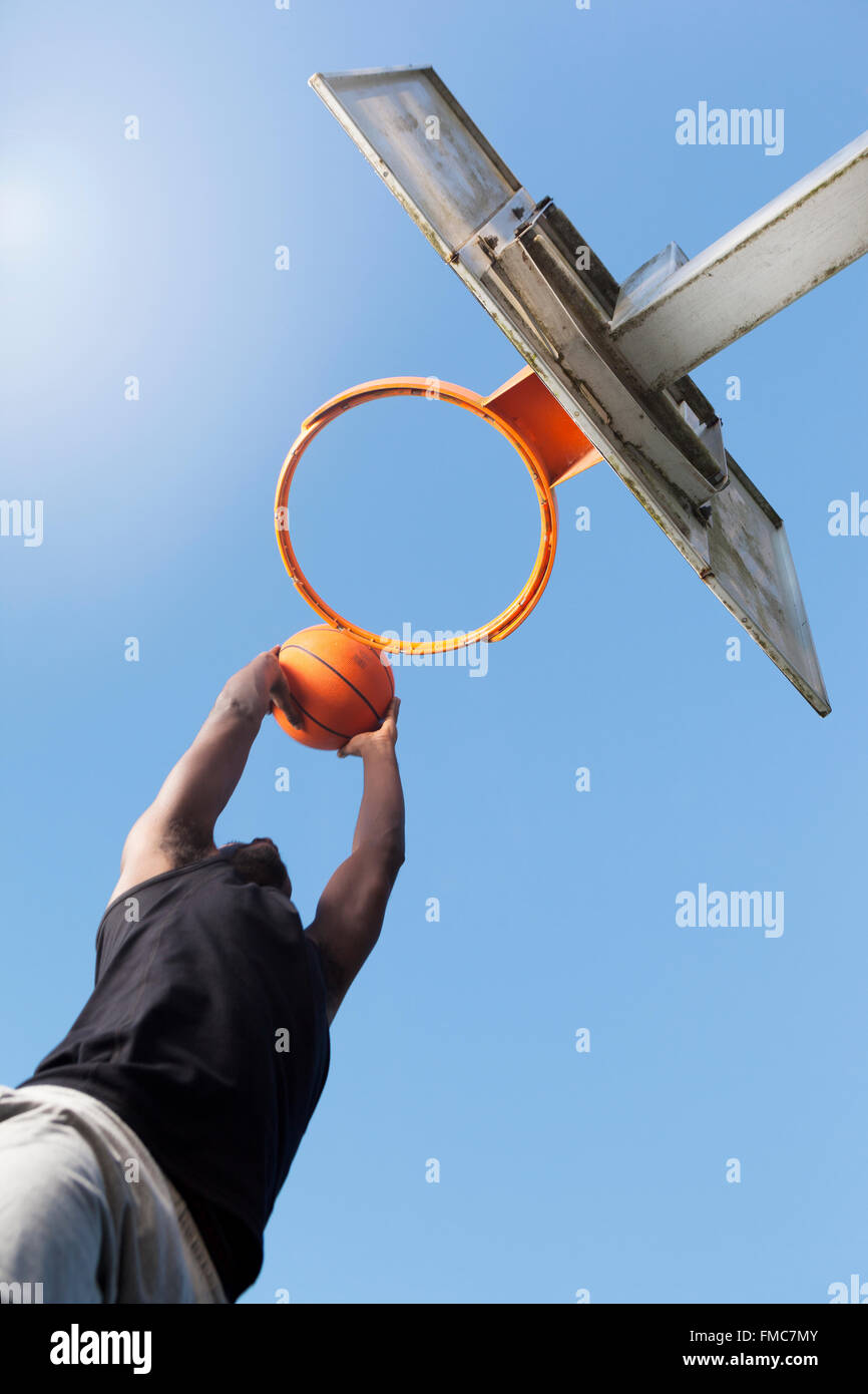 Basketball player jumping to dunk Stock Photo - Alamy