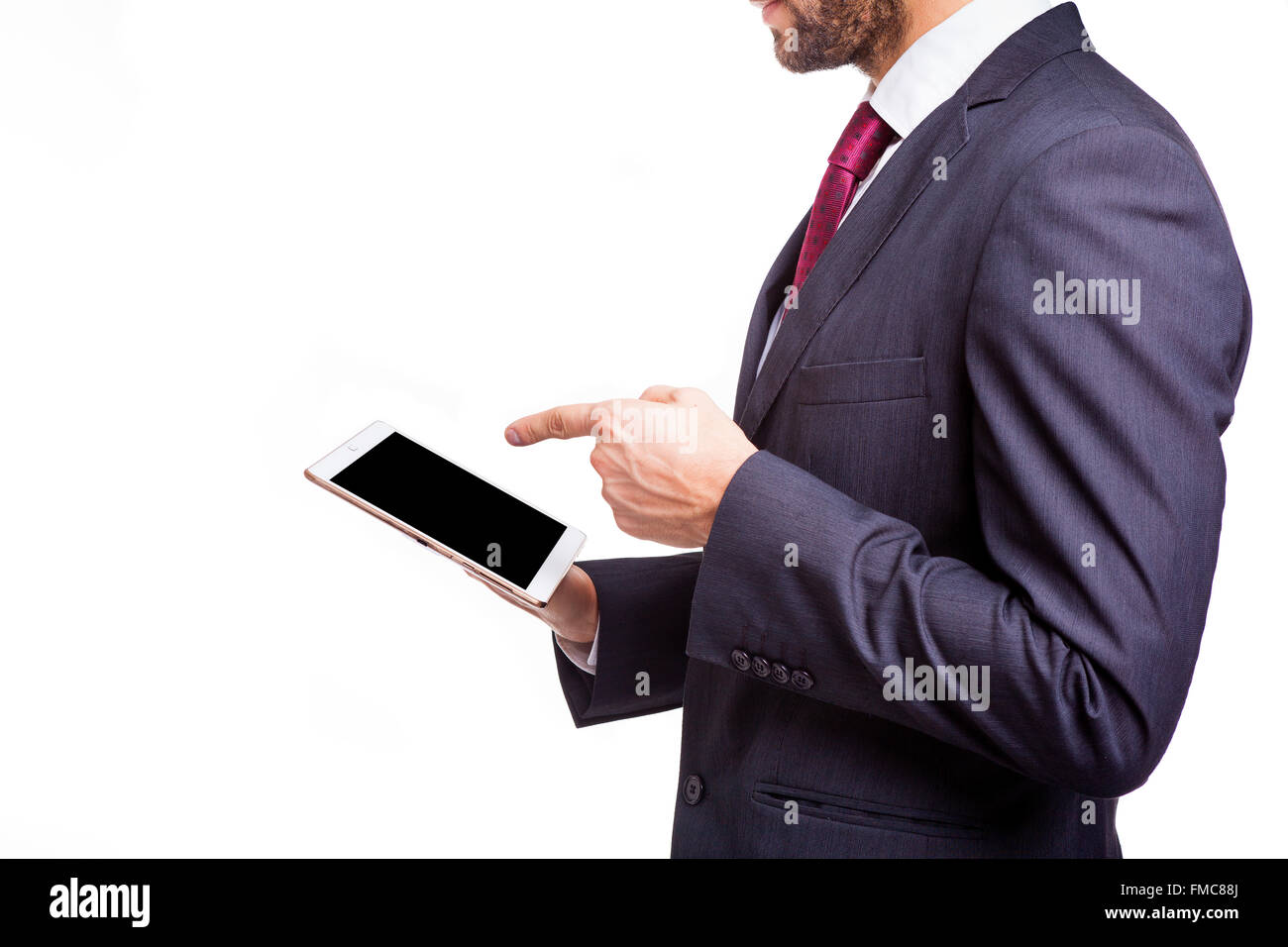 Businessman pointing to his tablet computer, isolated on white ...