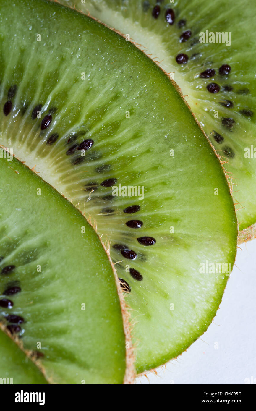 close up of a fresh kiwi sliced in half revealing a beautiful pattern ...