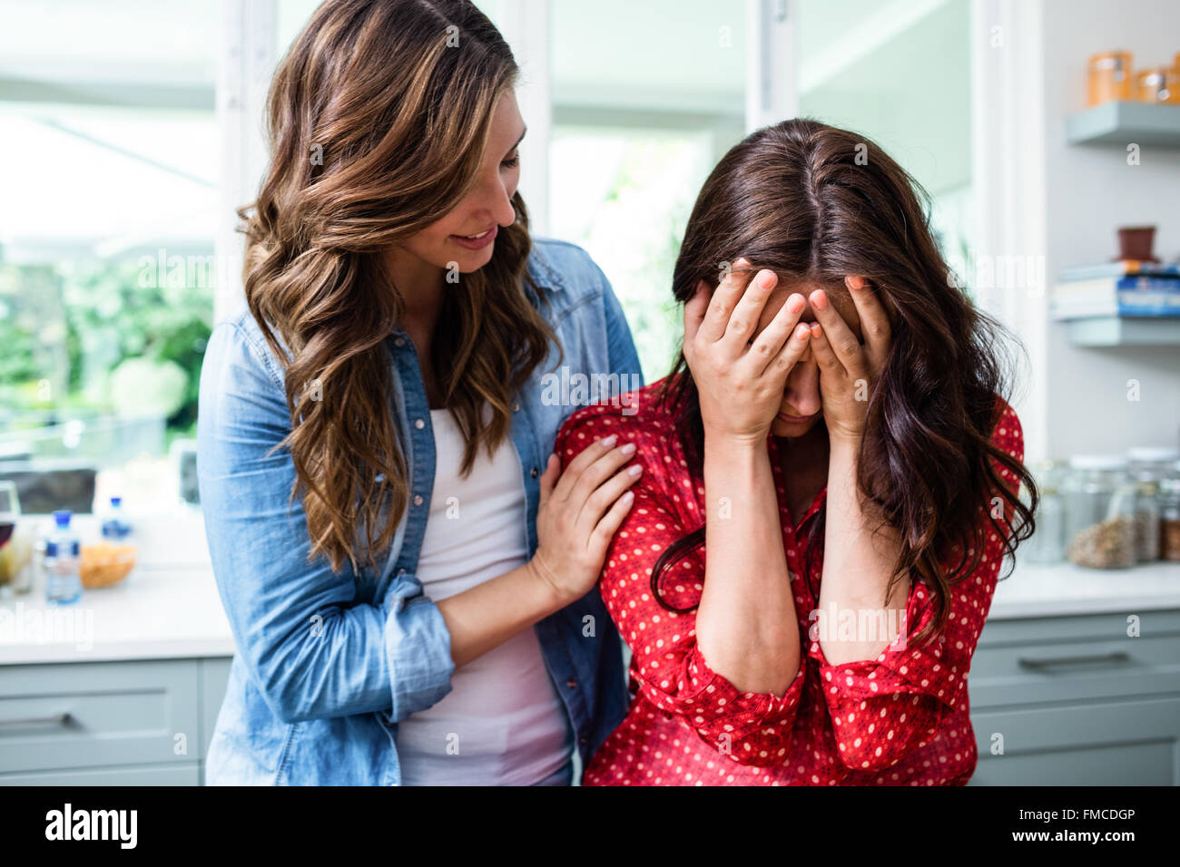 Woman comforting worried friend Stock Photo - Alamy
