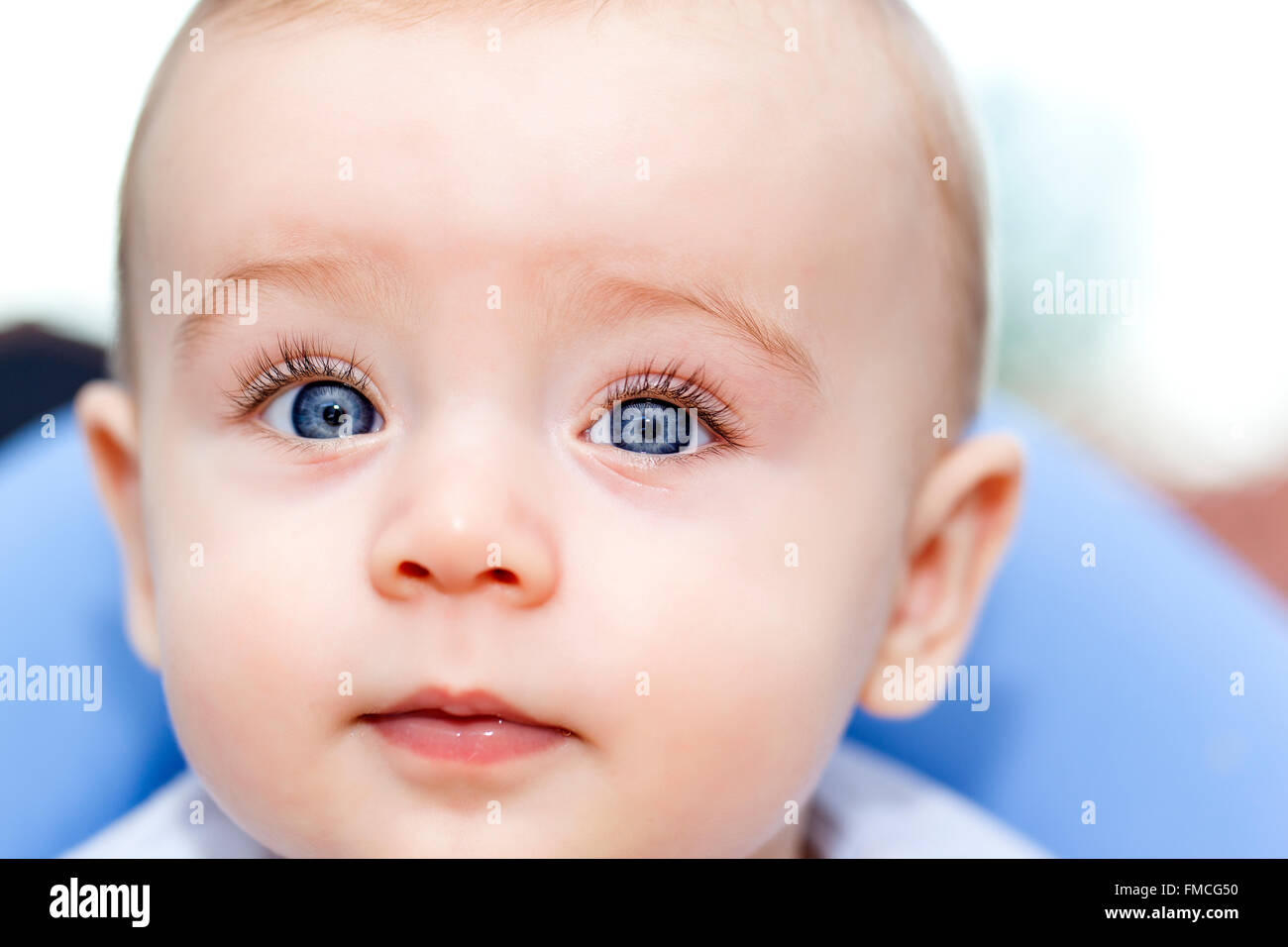 Headshot of a baby with blue eyes looking to the camera Stock Photo - Alamy