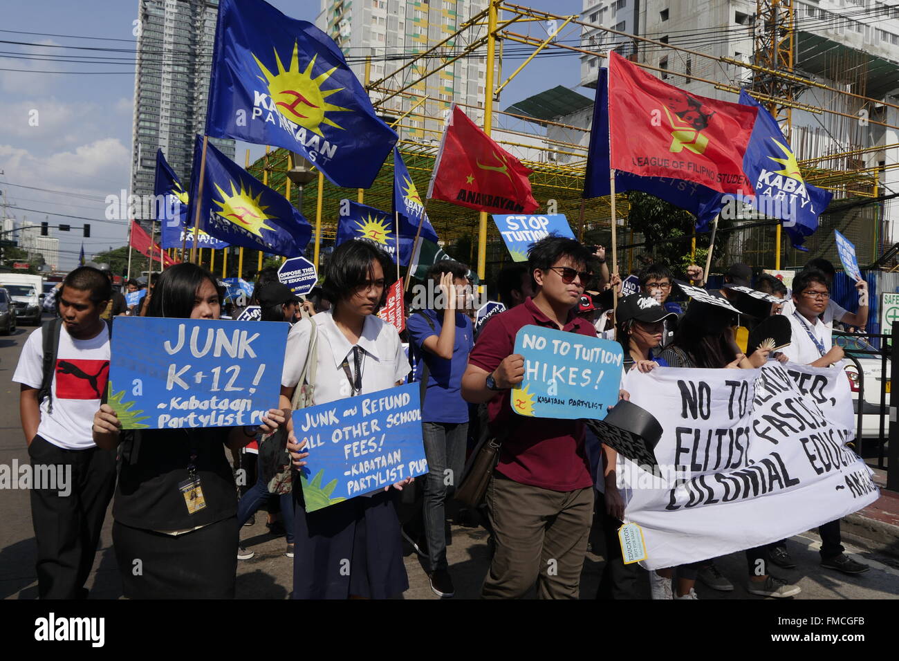 Flags and placards are held up while students march towards Recto. Once ...