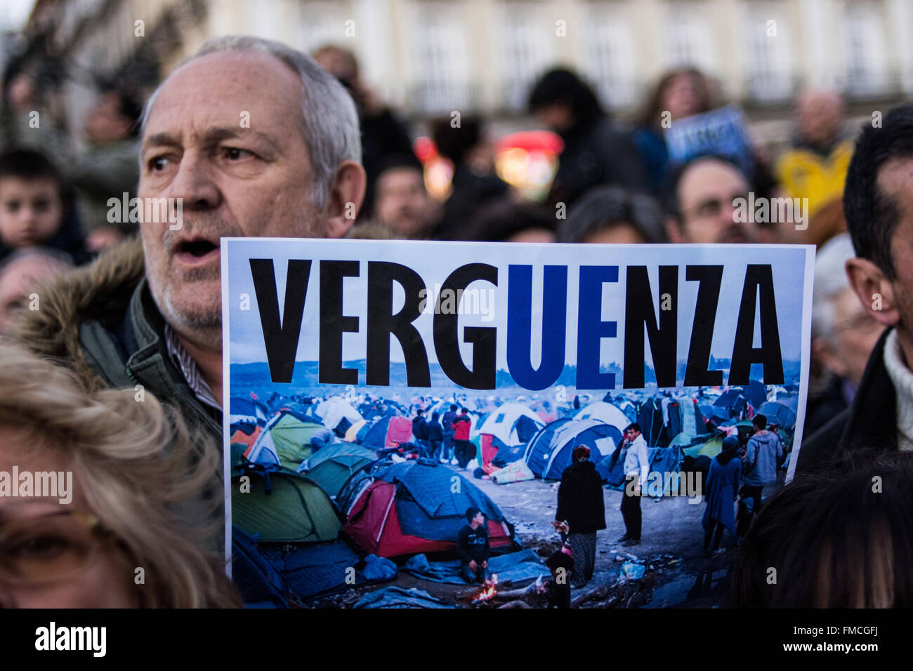 Madrid, Spain. 11th Mar, 2016. People with pictures of refugees camps ...