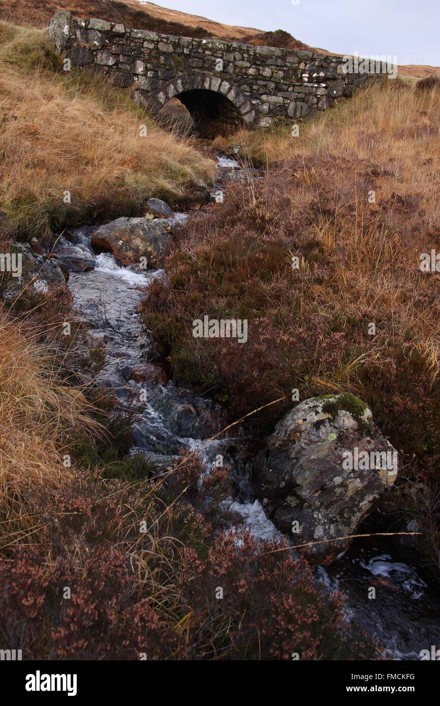 Stream flowing under old stone bridge. Rannoch Moor, nr Glencoe ...