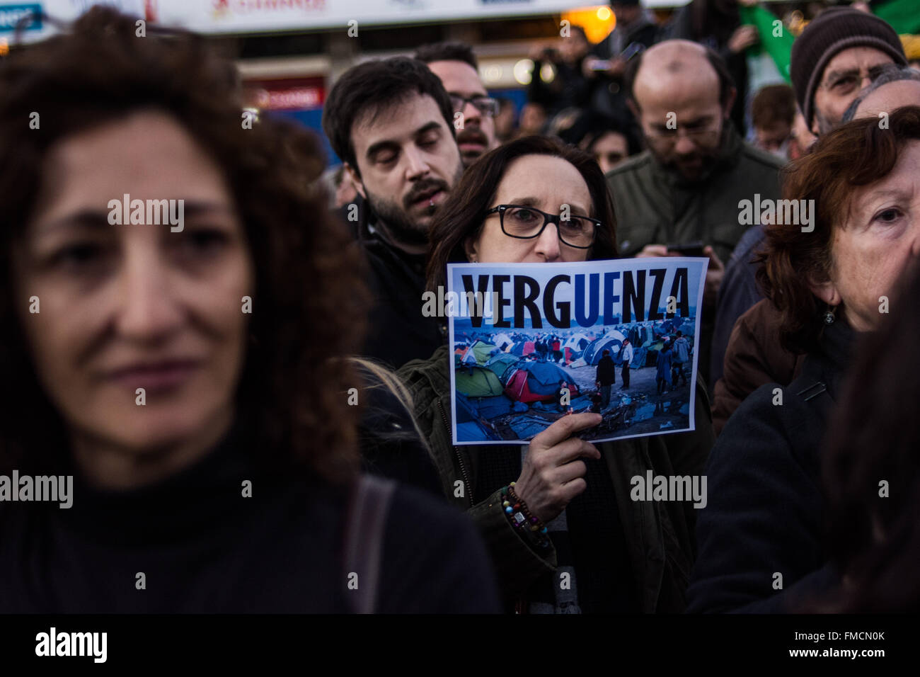 Madrid, Spain. 11th Mar, 2016. People with pictures of refugees camps ...