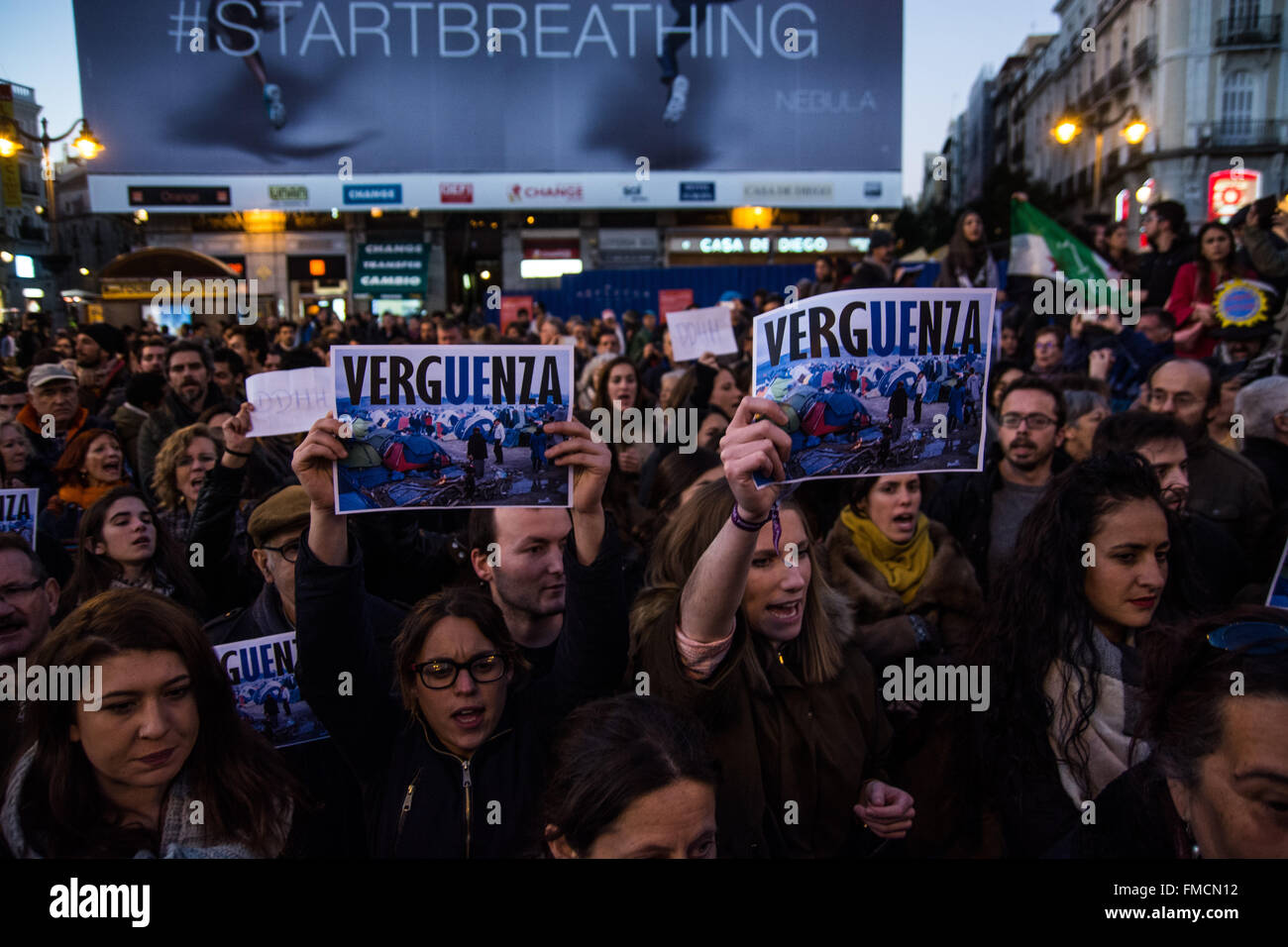 Madrid, Spain. 11th Mar, 2016. People with pictures of refugees camps ...