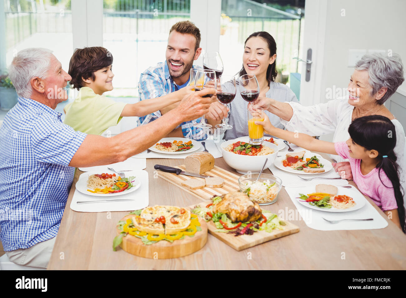 Smiling family toasting drinks Stock Photo - Alamy