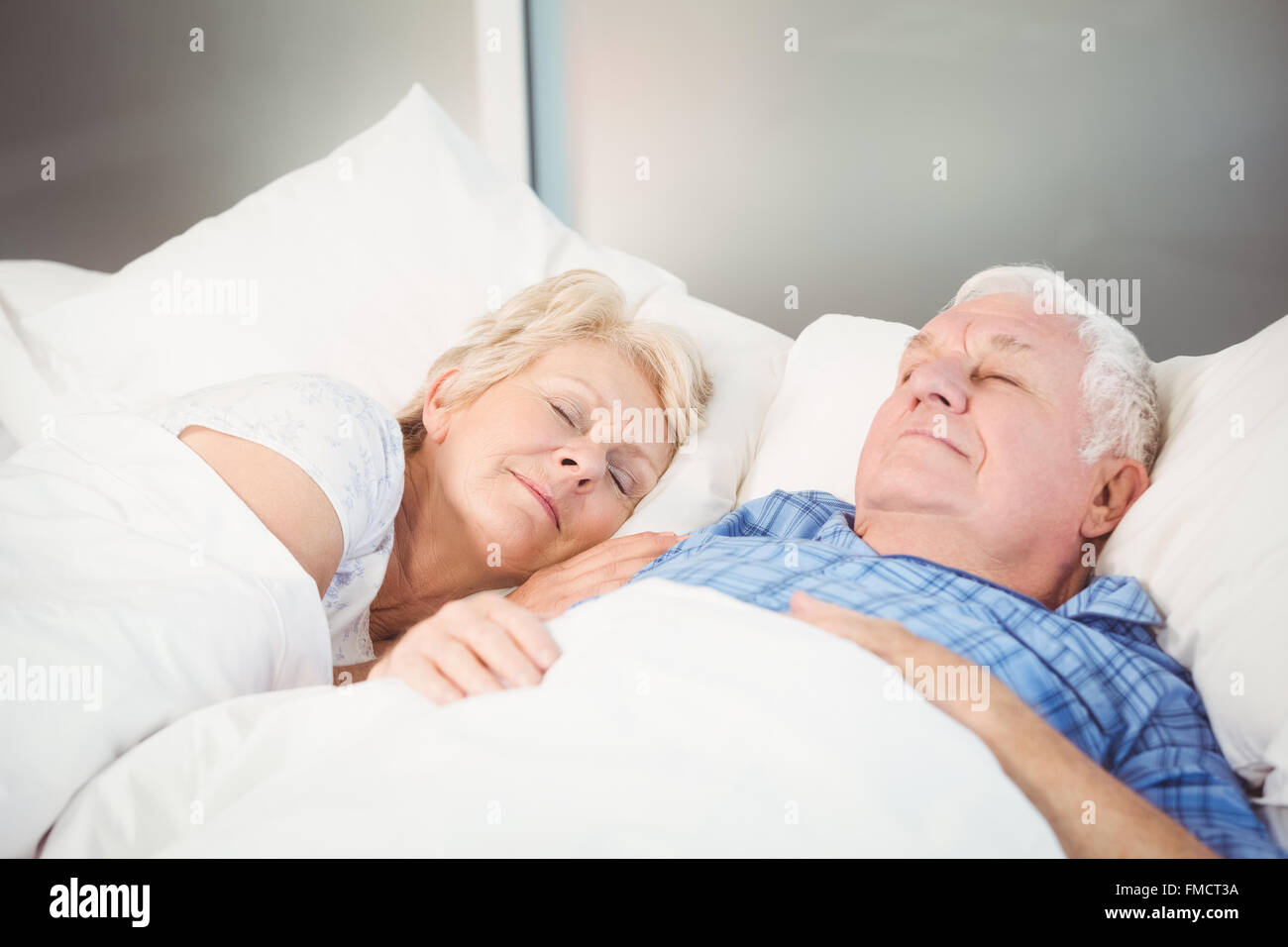 Couple sleeping together on bed Stock Photo - Alamy