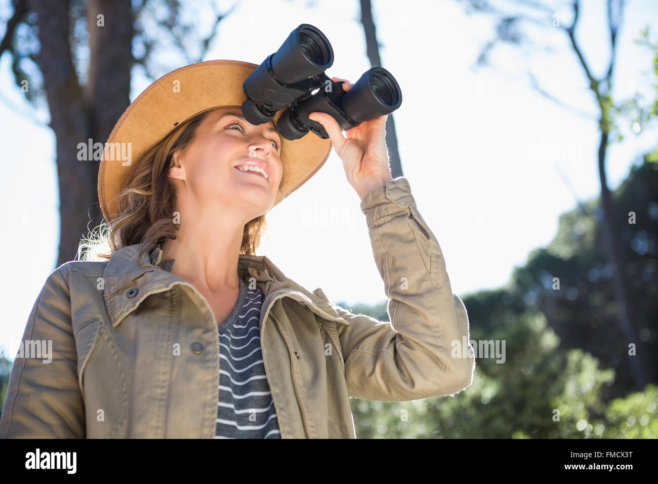 Woman using binoculars Stock Photo - Alamy