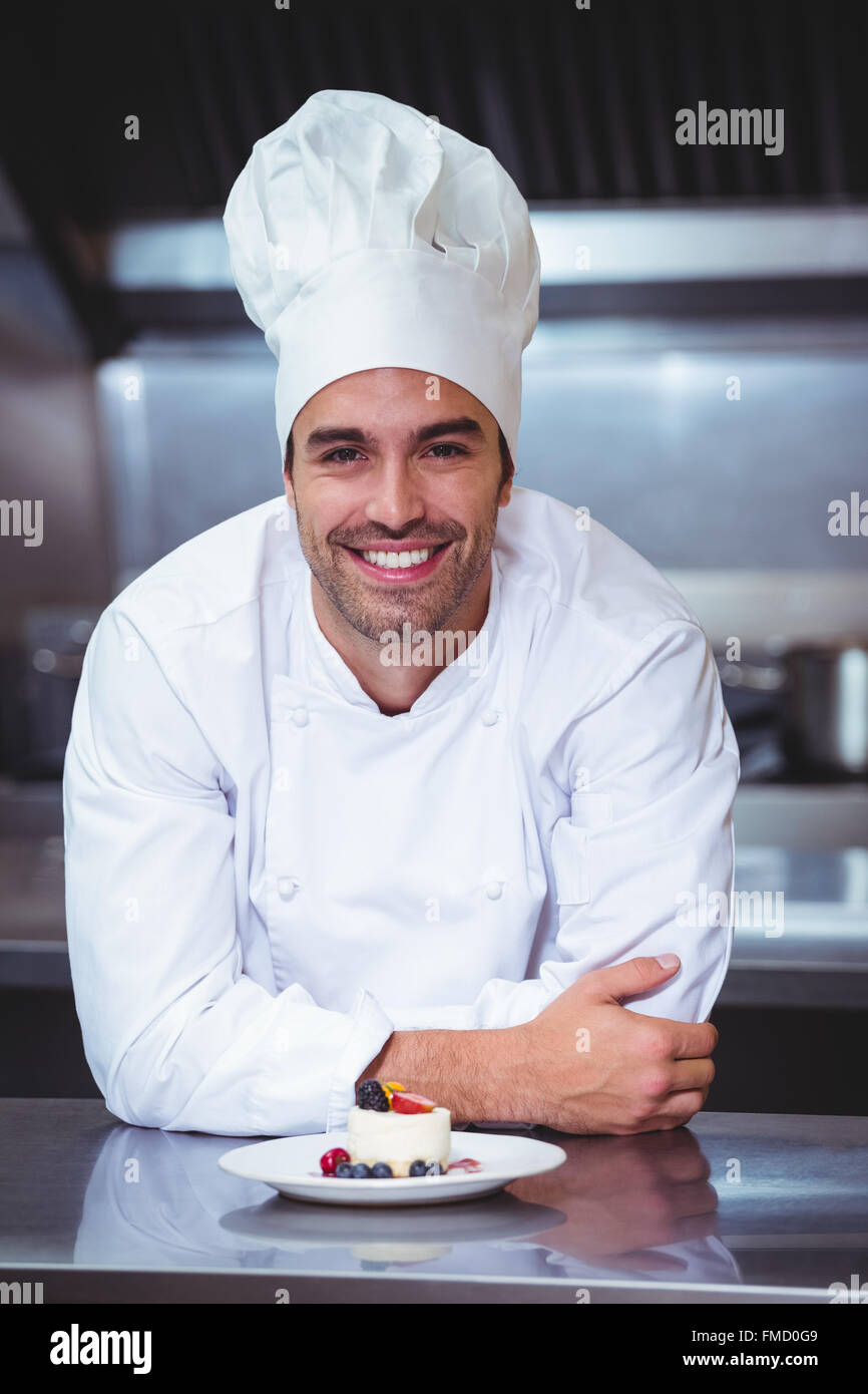 Chef leaning on the counter with a dessert Stock Photo - Alamy