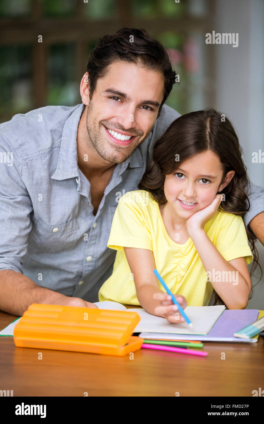 Portrait of smiling father and daughter studying Stock Photo - Alamy