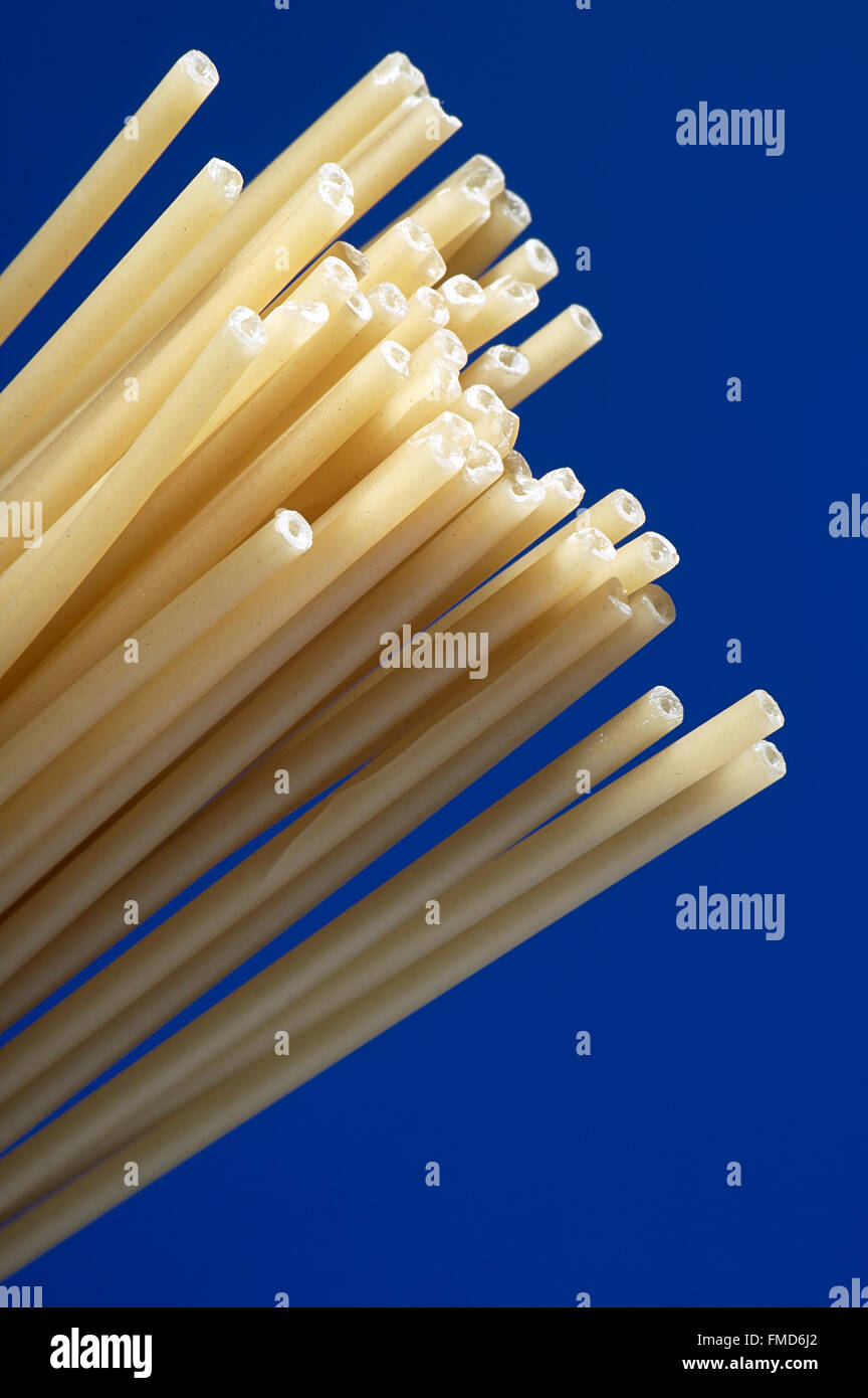 Long macaroni on a dark blue background Stock Photo - Alamy