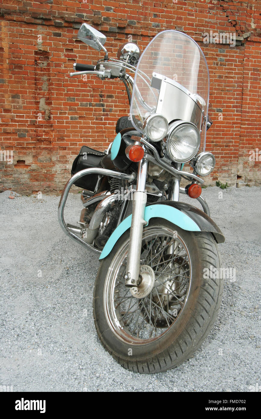 Old blue motorcycle at a brick wall Stock Photo - Alamy