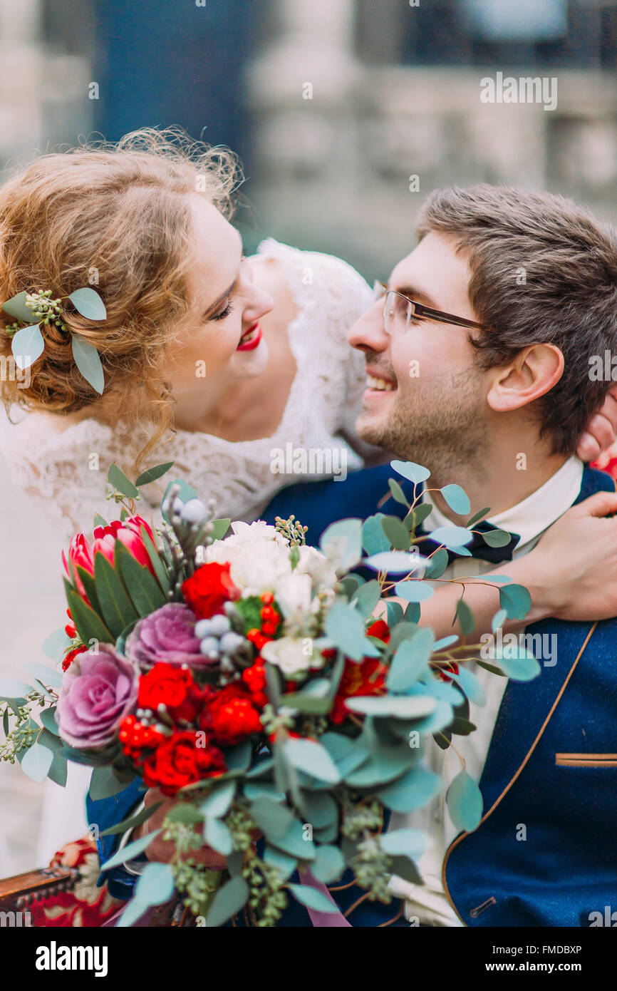Happy bride and groom hugging and laughing with eyes closed Stock Photo ...
