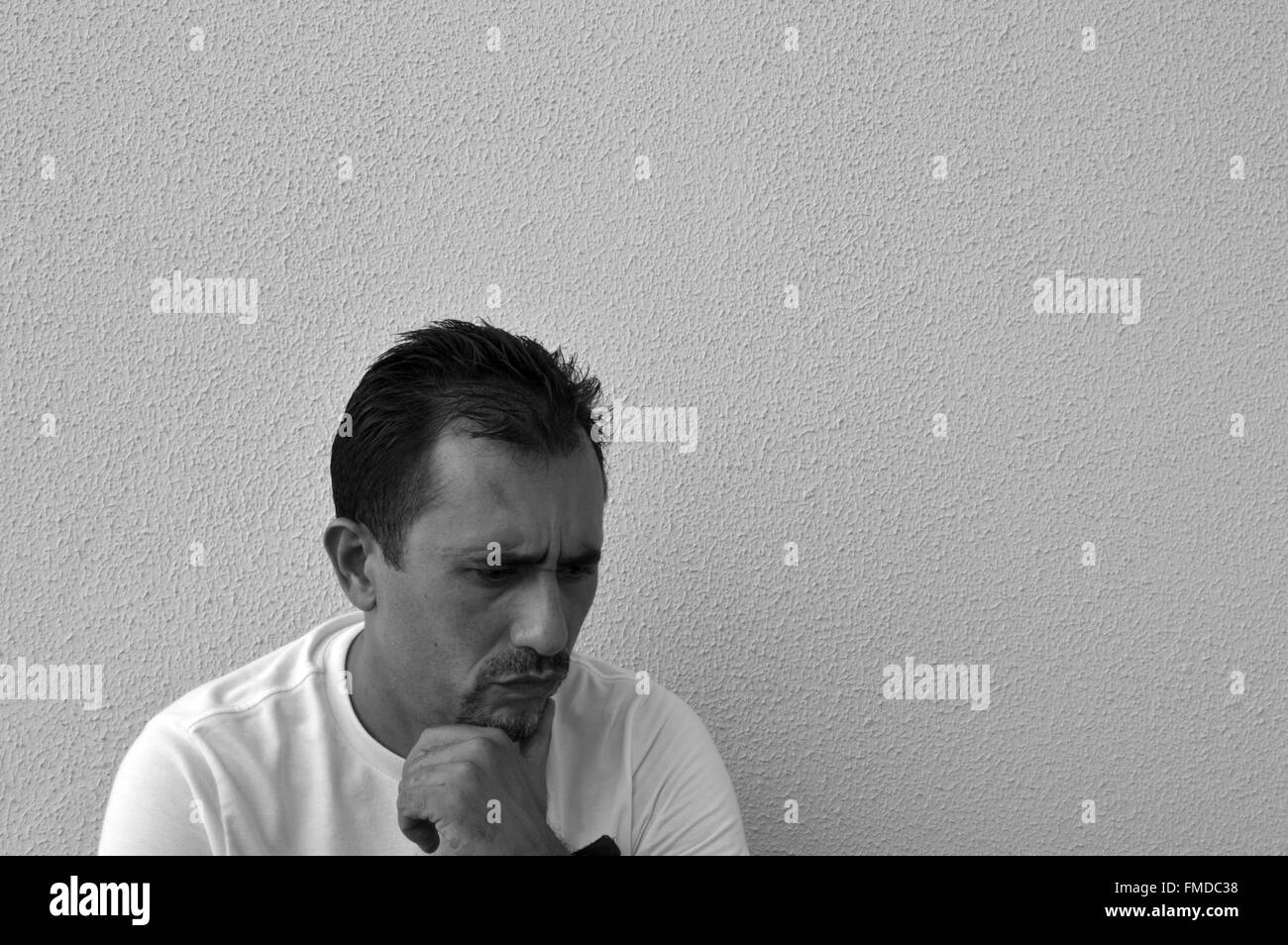 Sad Latino Man Thinking Textured Wall Background Stock Photo - Alamy