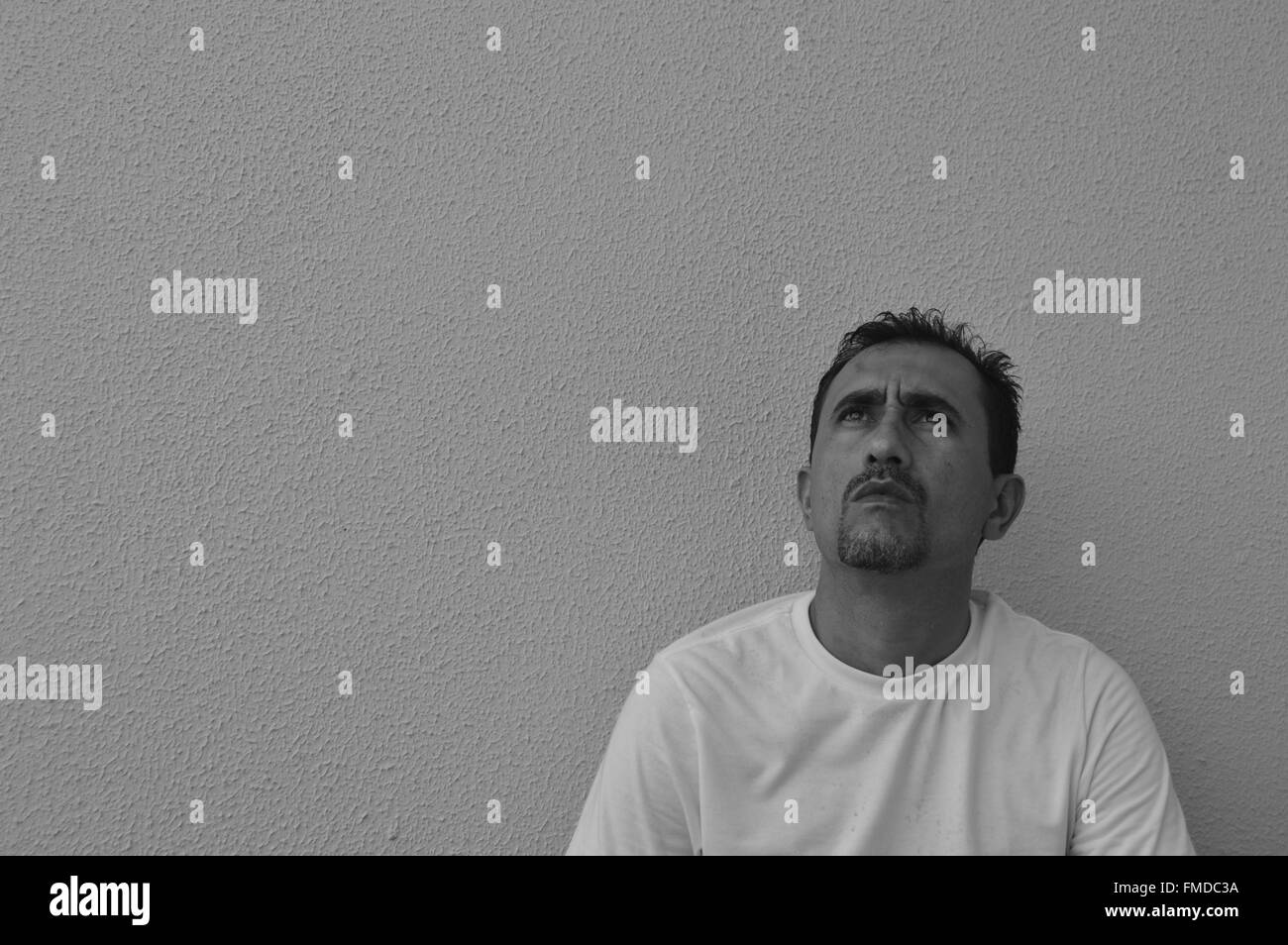 Sad Latino Man Thinking Textured Wall Background Stock Photo - Alamy