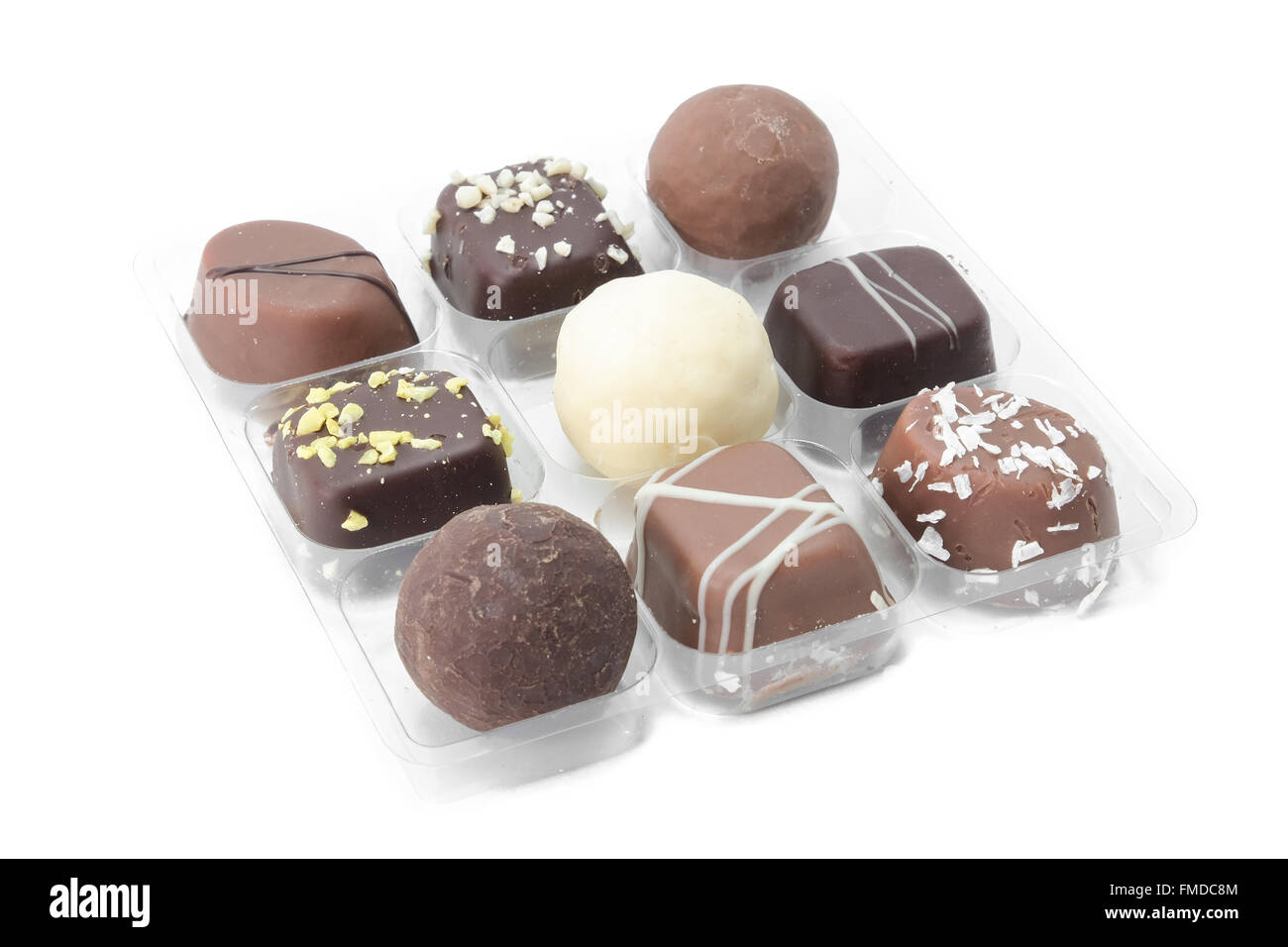assorted chocolate bites in a small plastic box with individual rooms ...