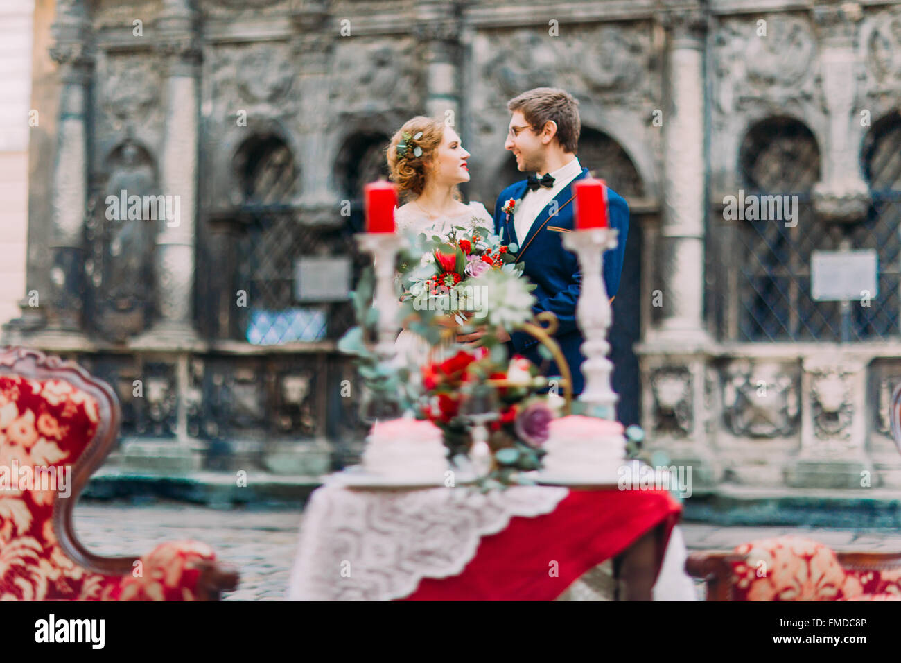 Newlyweds lovingly look at each other with the vintage decorated with ...