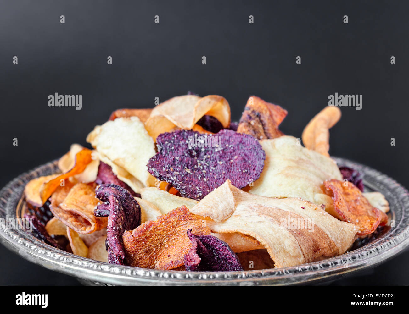 Vintage plate of crunchy vegetable crisps in a vintage silver plate ...