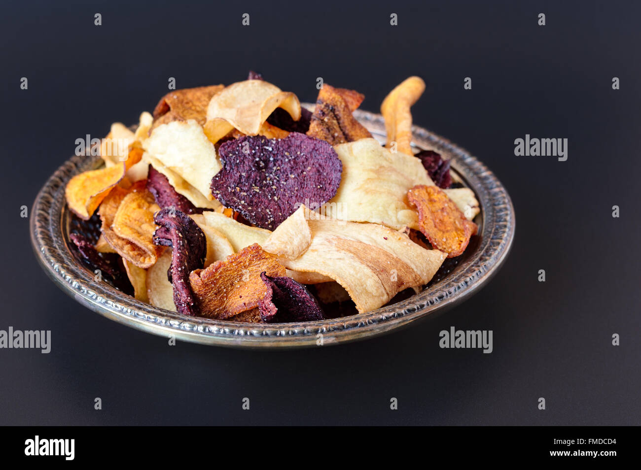 Vintage plate of crunchy vegetable crisps in a vintage silver plate ...