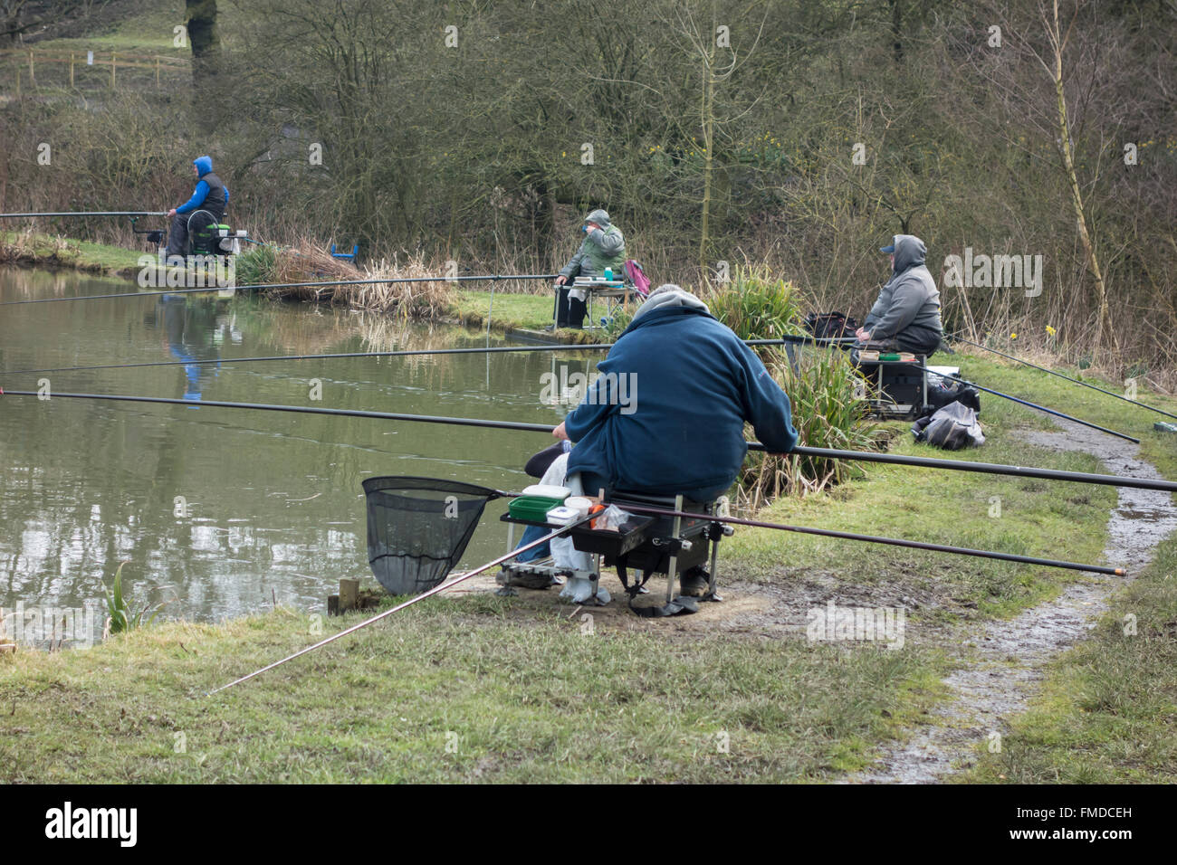 Men fishing, angling for fish around a pond, small lake Stock Photo - Alamy