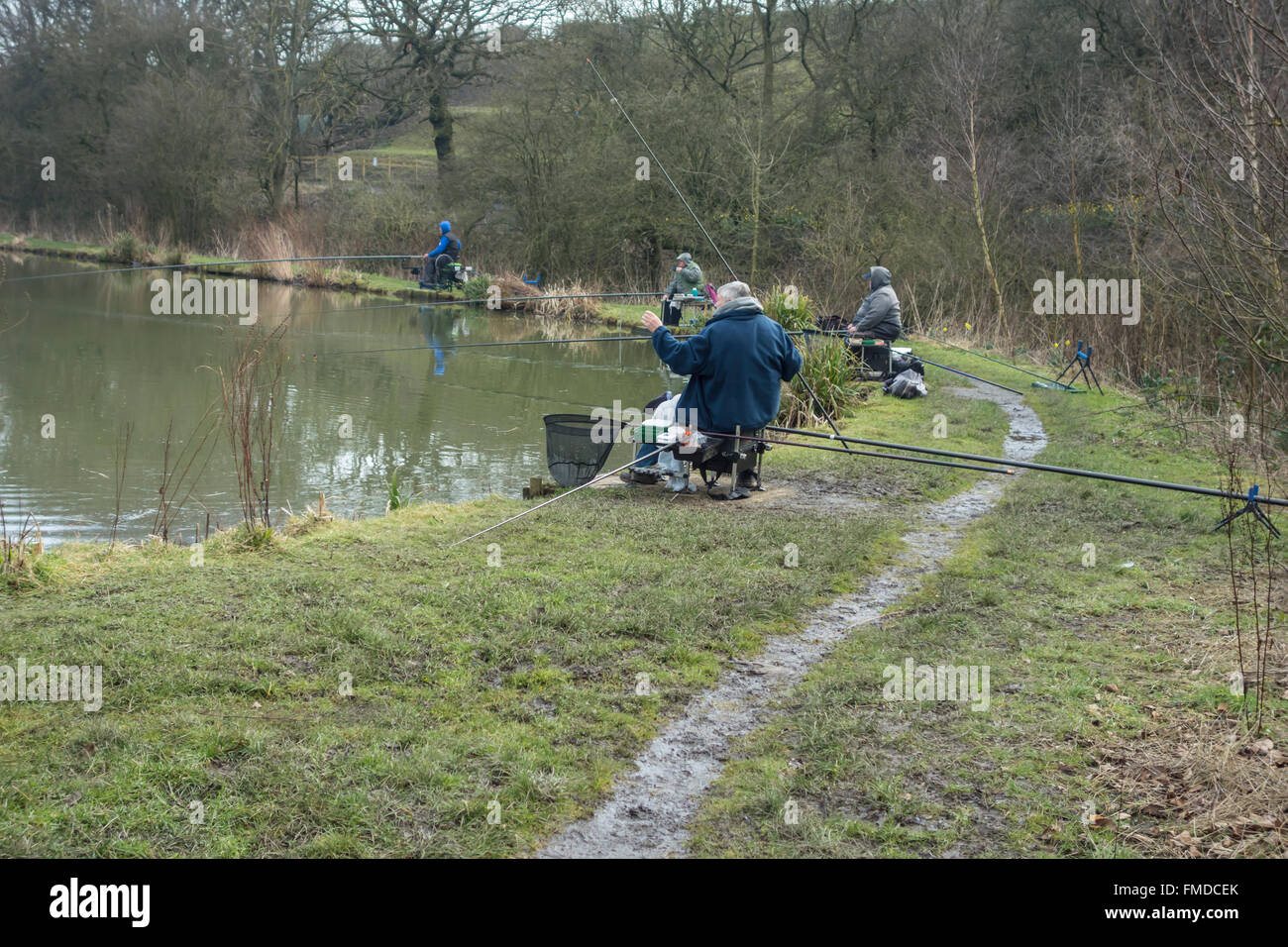 Men fishing, angling for fish around a pond, small lake Stock Photo - Alamy