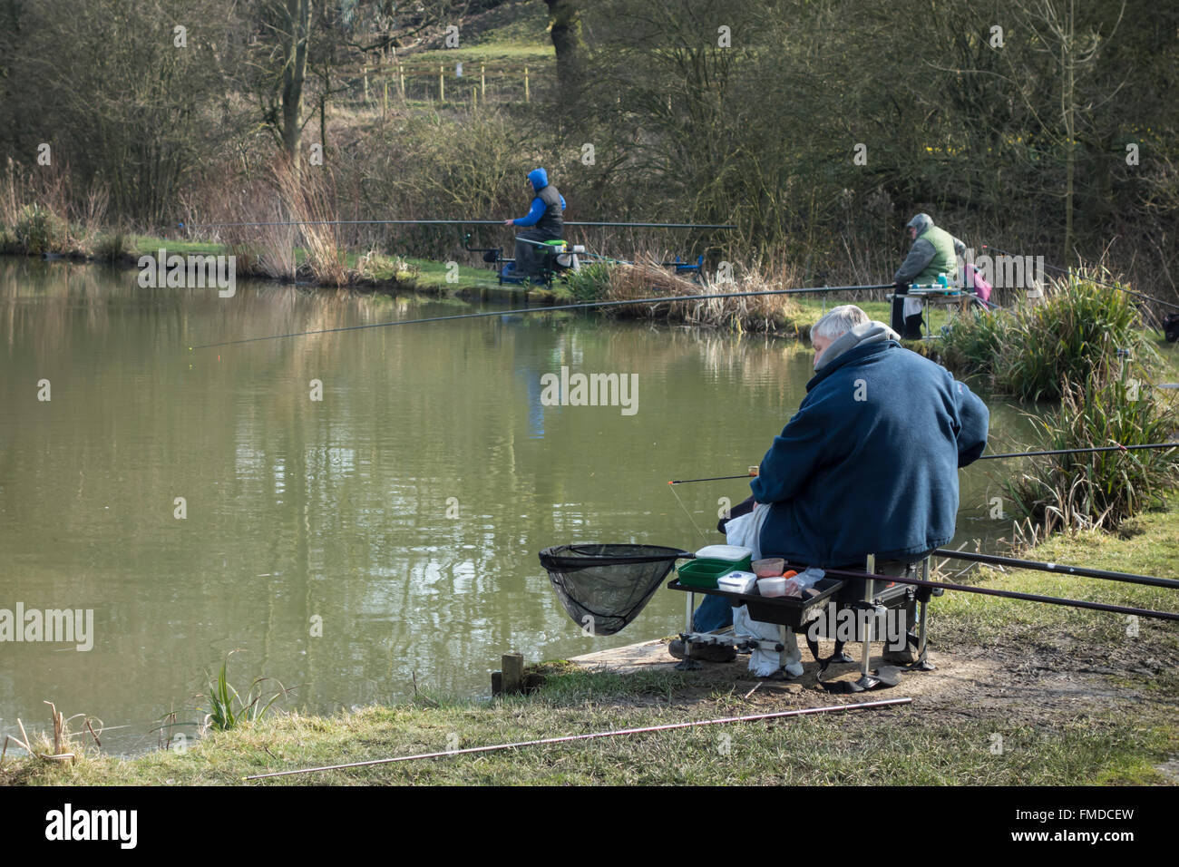 Men fishing, angling for fish around a pond, small lake Stock Photo - Alamy
