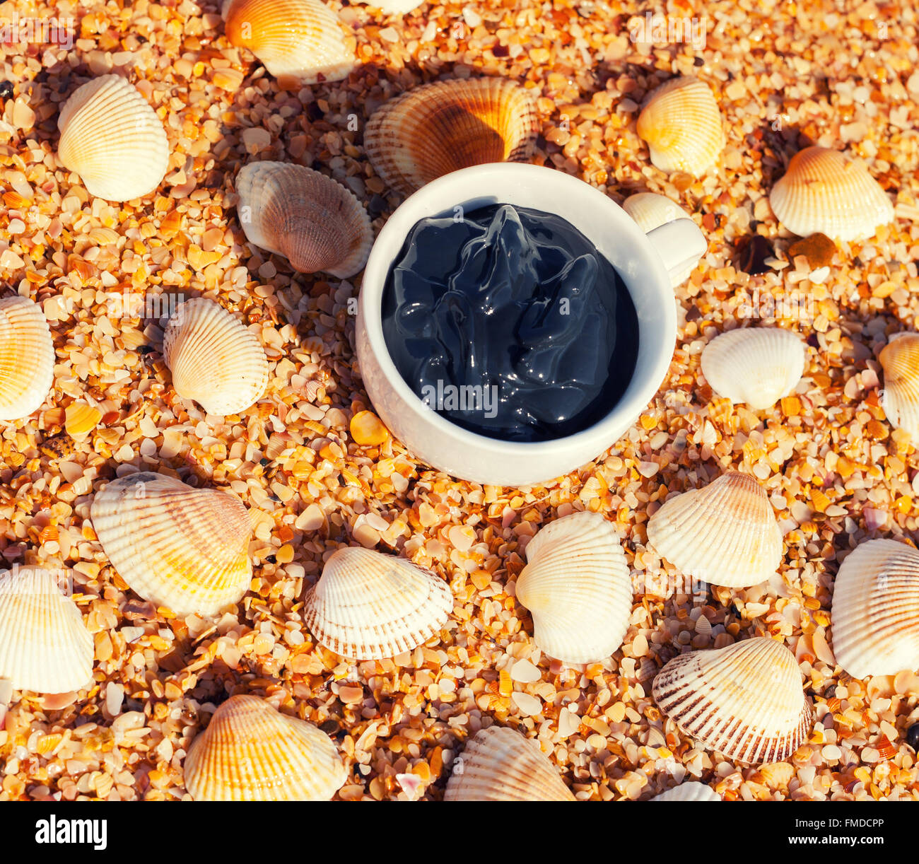 Dead sea mud for spa treatments in a cup on the beach with shell Stock ...