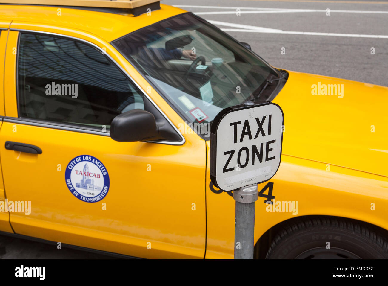 Yellow taxi waiting for fare at taxi zone in downtown hi-res stock ...