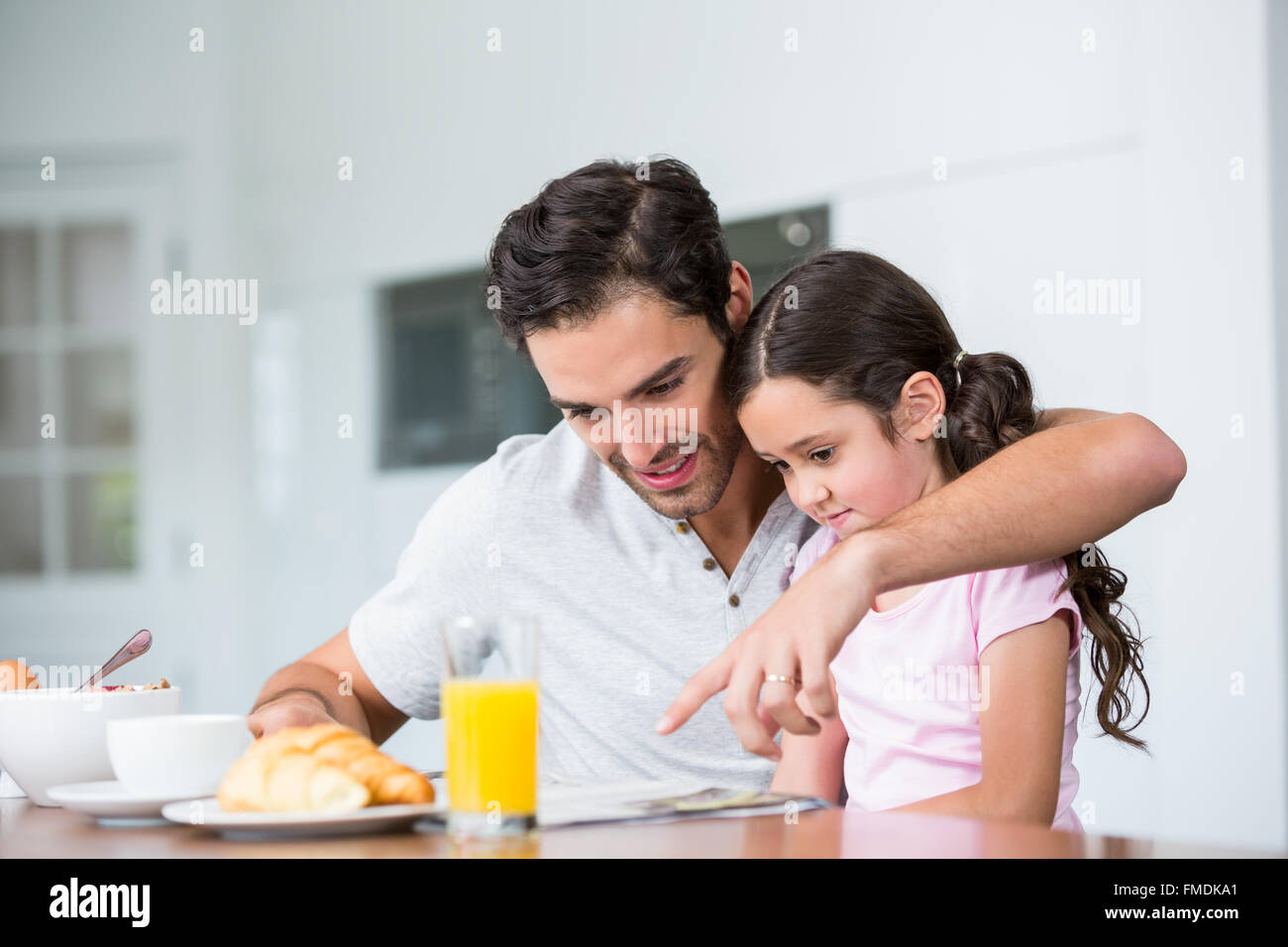 Father and daughter reading newspaper Stock Photo - Alamy