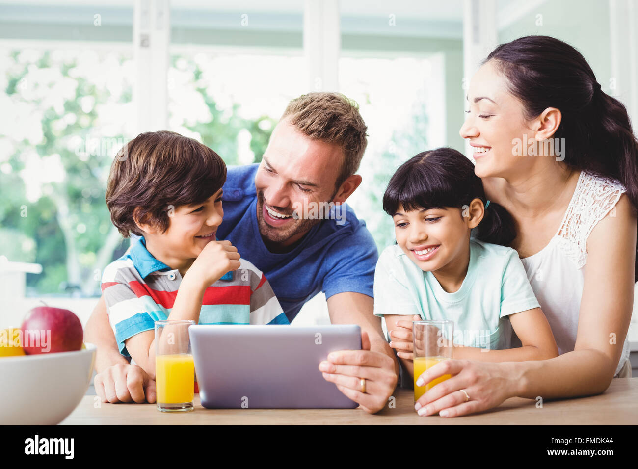 Happy family using digital tablet Stock Photo - Alamy