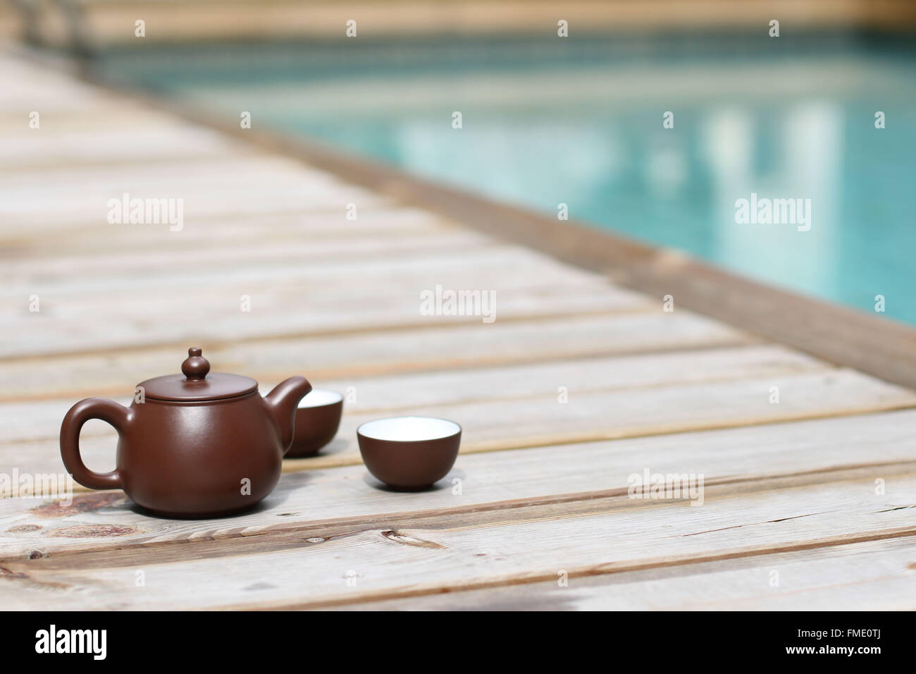 Chinese Tea pot and tea cup by the swimming pool Stock Photo - Alamy