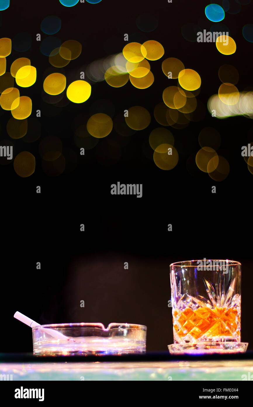 Glass of whiskey on top of the bar and cigarette Stock Photo - Alamy