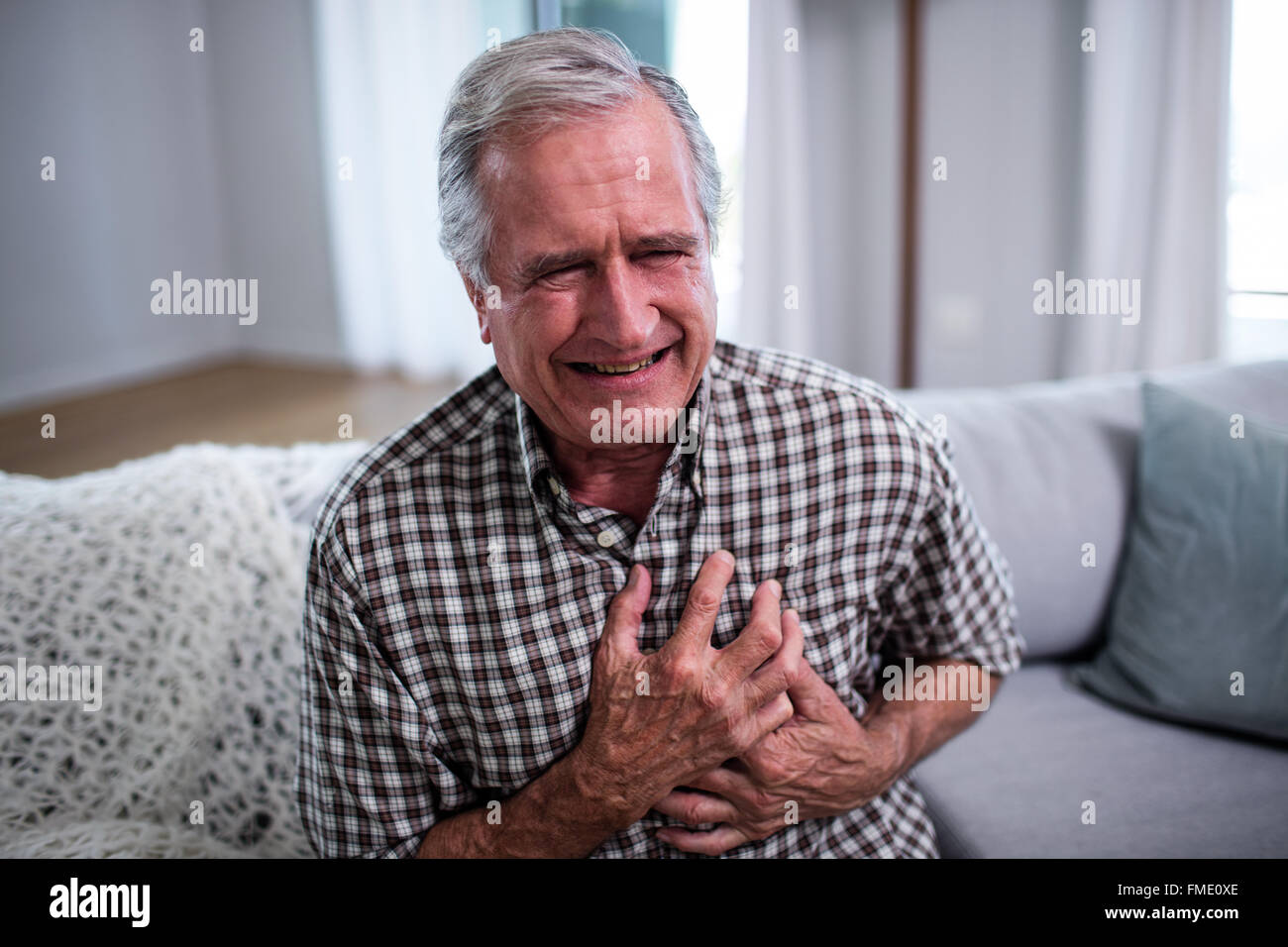 Senior man suffering from heart attack Stock Photo - Alamy