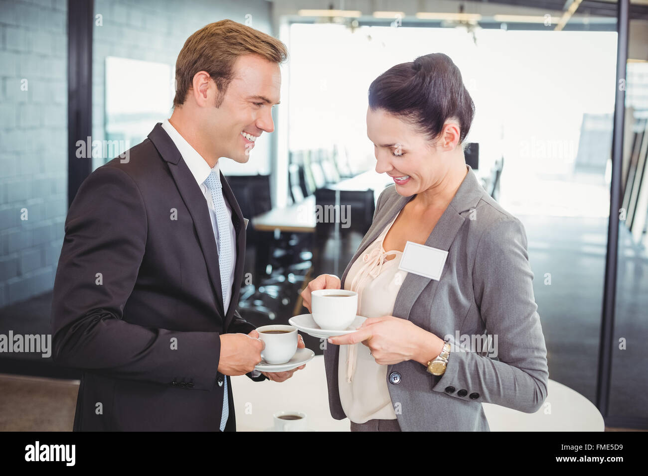 Businessman and businesswoman having tea during breaktime Stock Photo ...