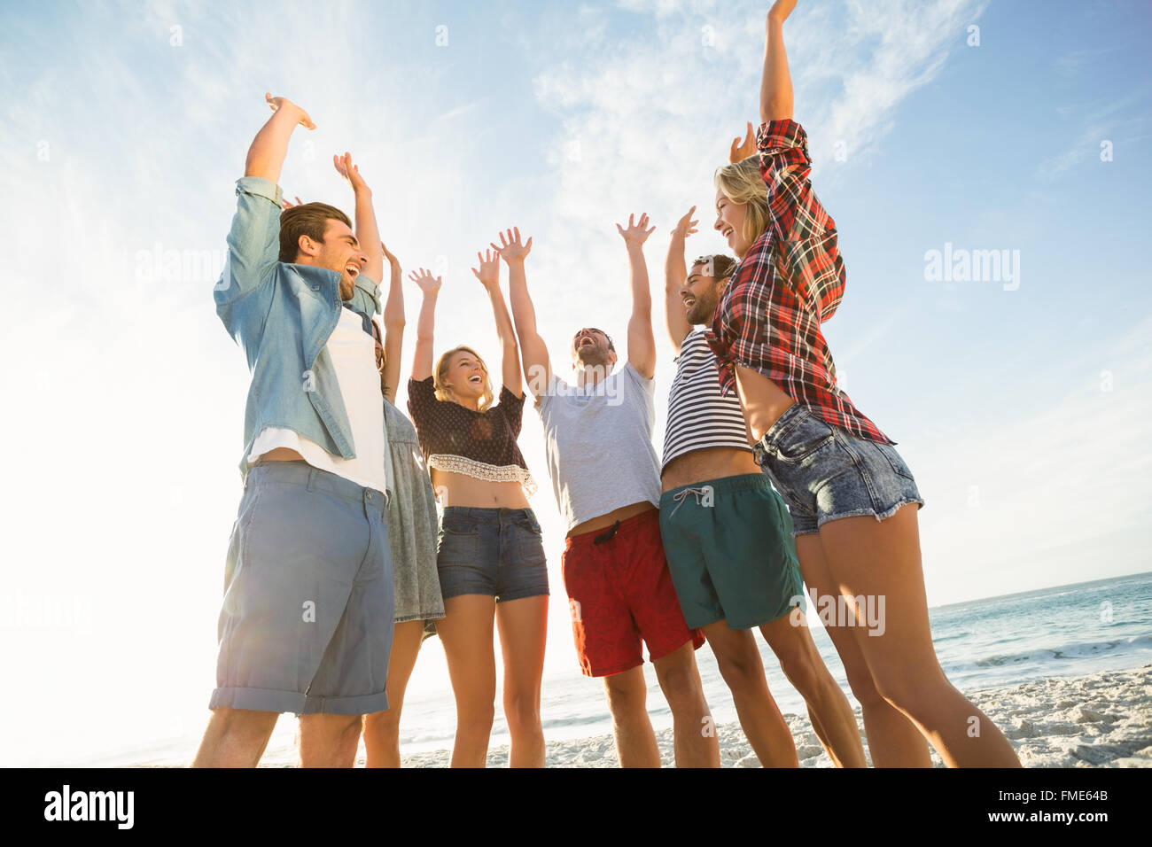 Friends raising their arms Stock Photo - Alamy