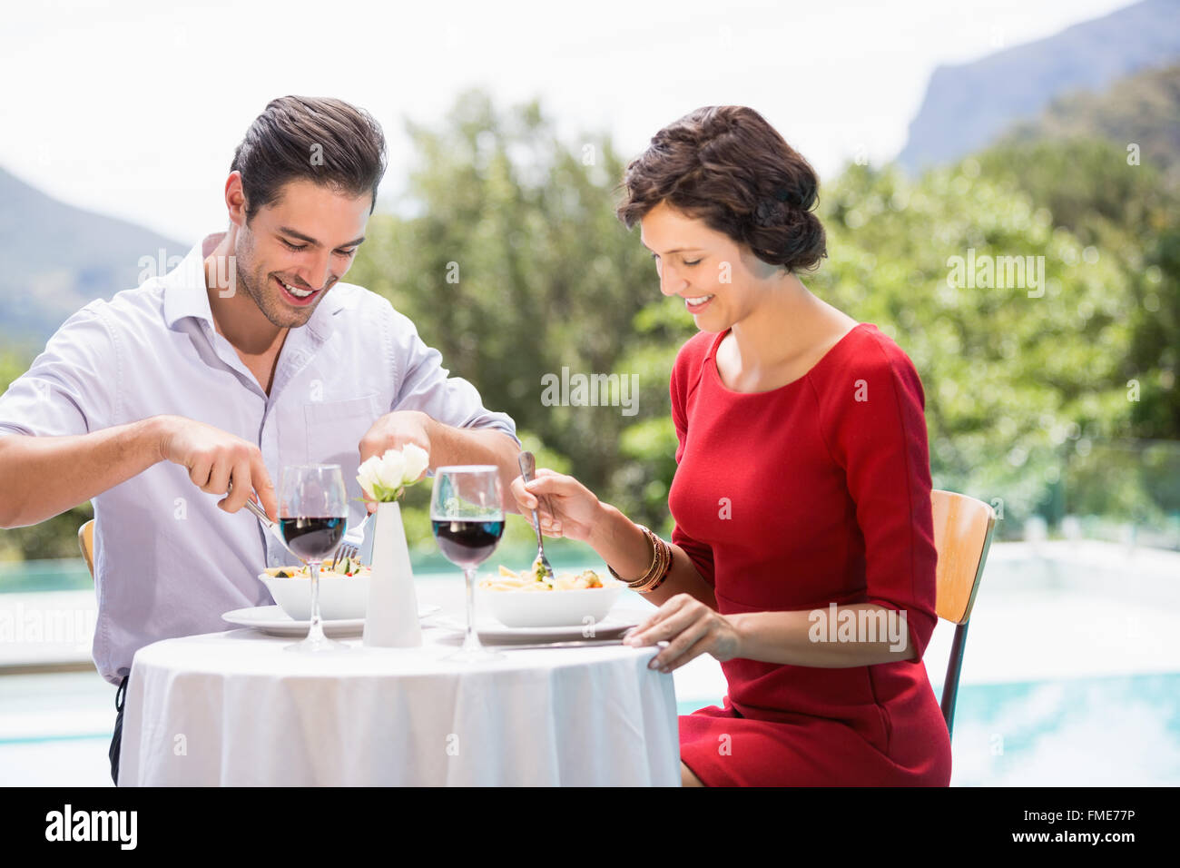 Smiling couple having food Stock Photo - Alamy
