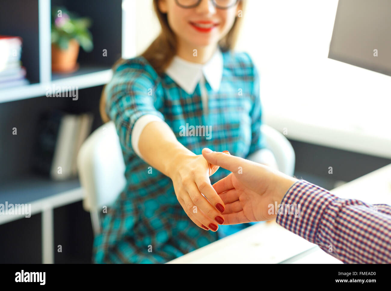 Modern young business woman with arm extended to handshake Stock Photo ...