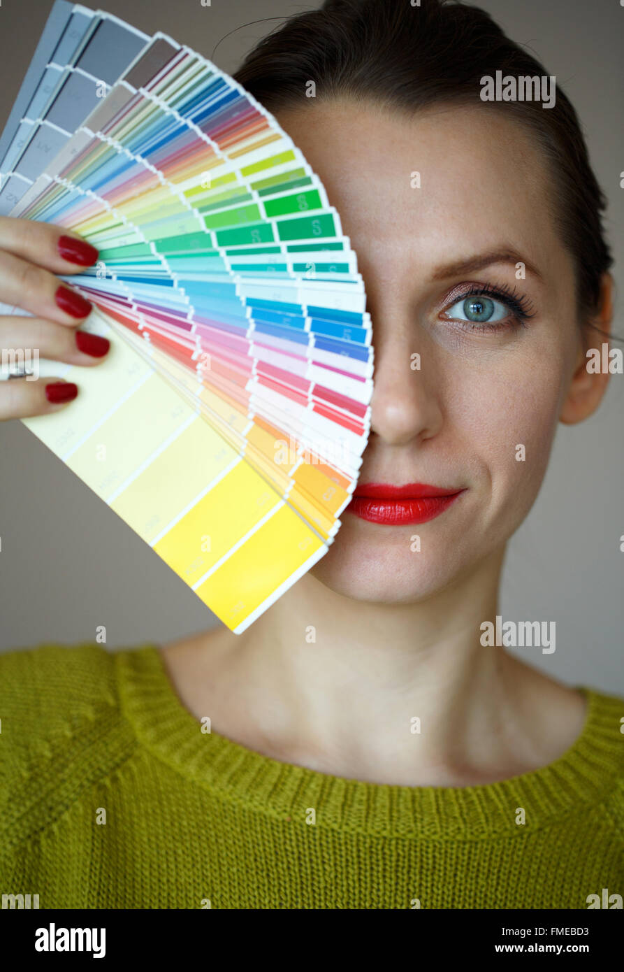 Woman with a red lips looking to a color paint palette - design concept ...
