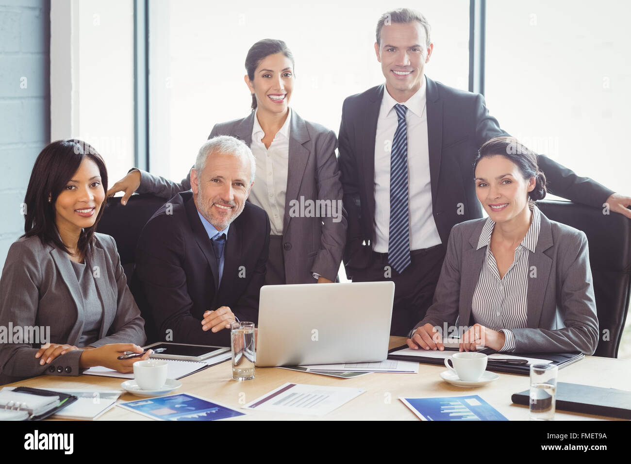 Businesspeople smiling in conference room Stock Photo - Alamy