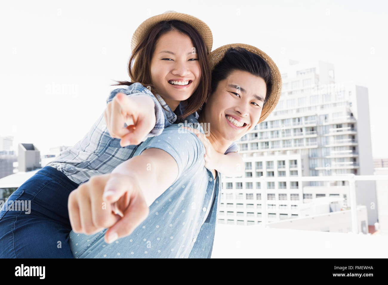 Young man giving a piggyback ride to woman Stock Photo - Alamy