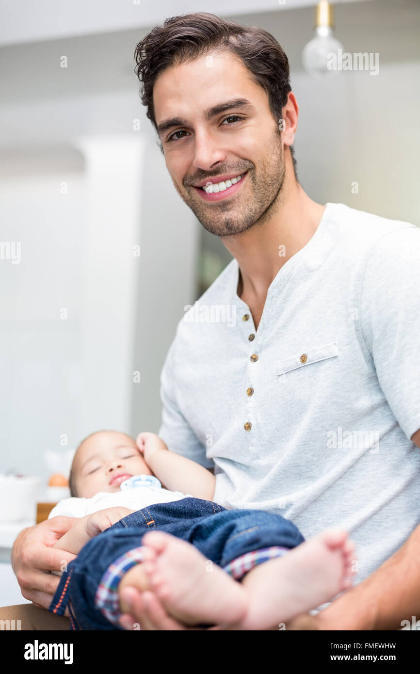 Portrait of smart father carrying baby Stock Photo - Alamy