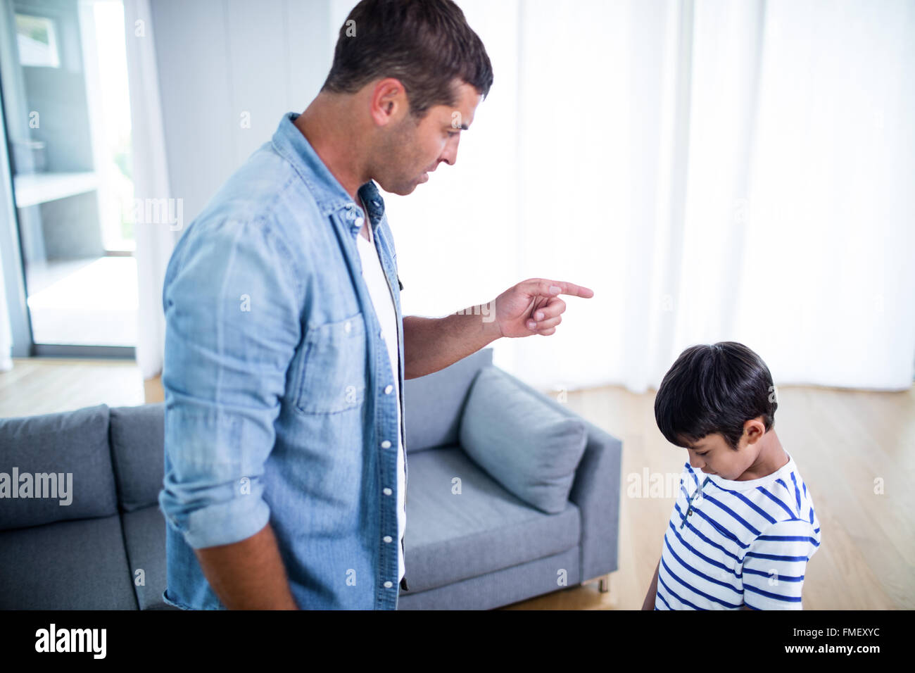 Angry father scolding his son Stock Photo - Alamy