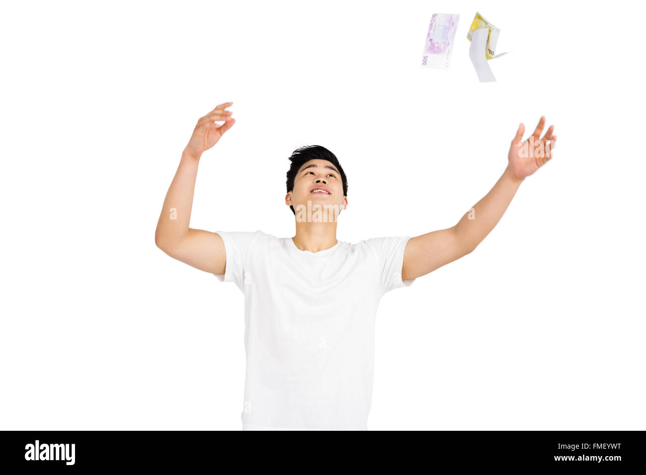 Young man throwing currency notes Stock Photo - Alamy
