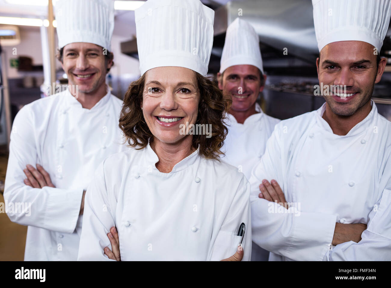 Happy chefs standing arm hi-res stock photography and images - Alamy
