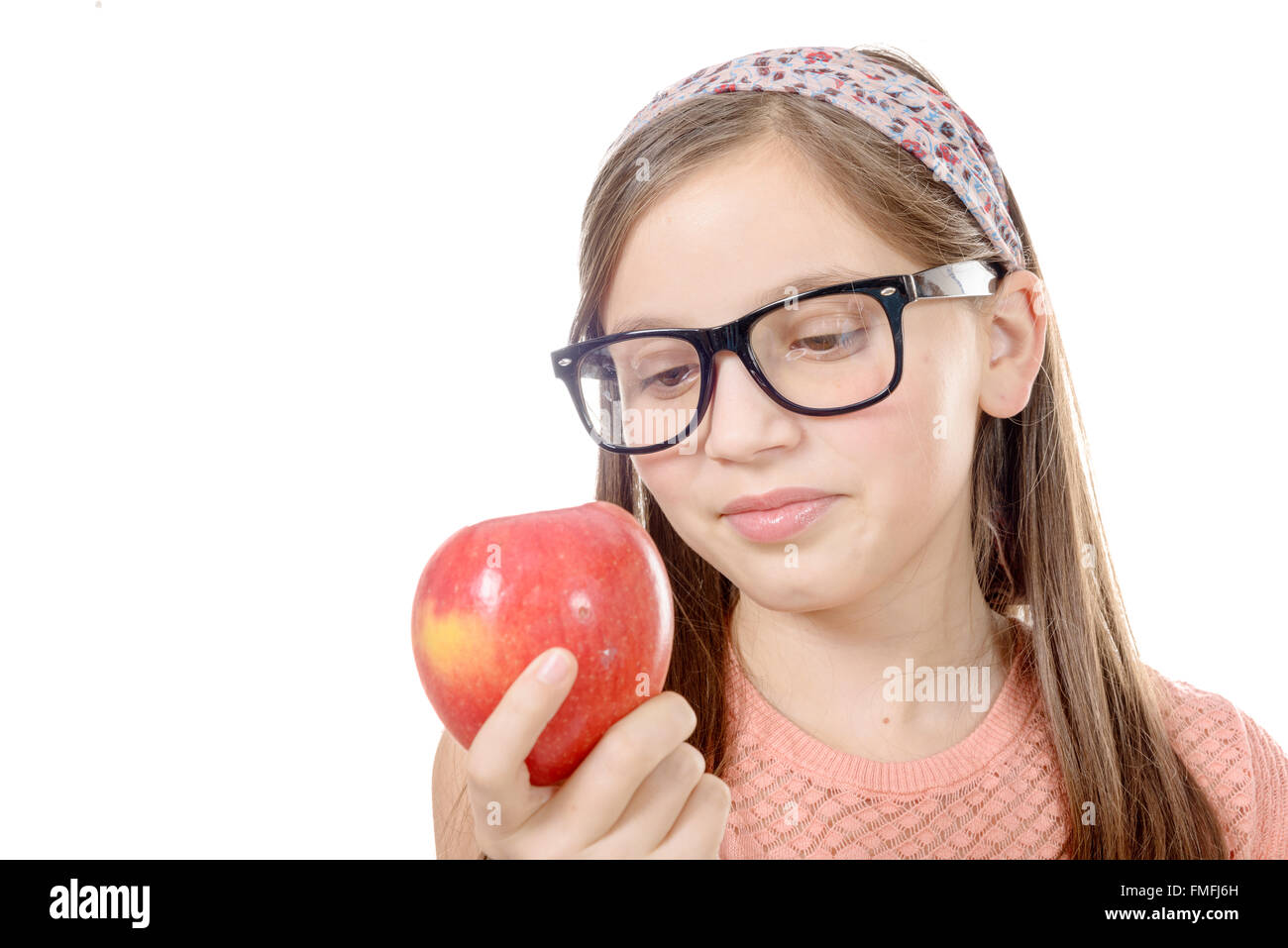a portrait of happy young girl eating an apple over white background ...